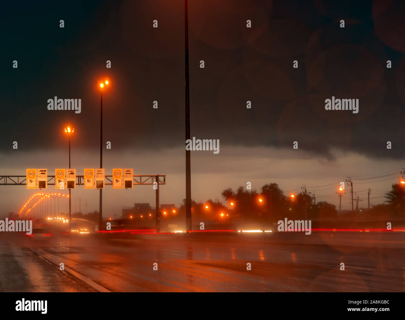 Street light at night in rainy day. Car and truck on asphalt road. Dark ...
