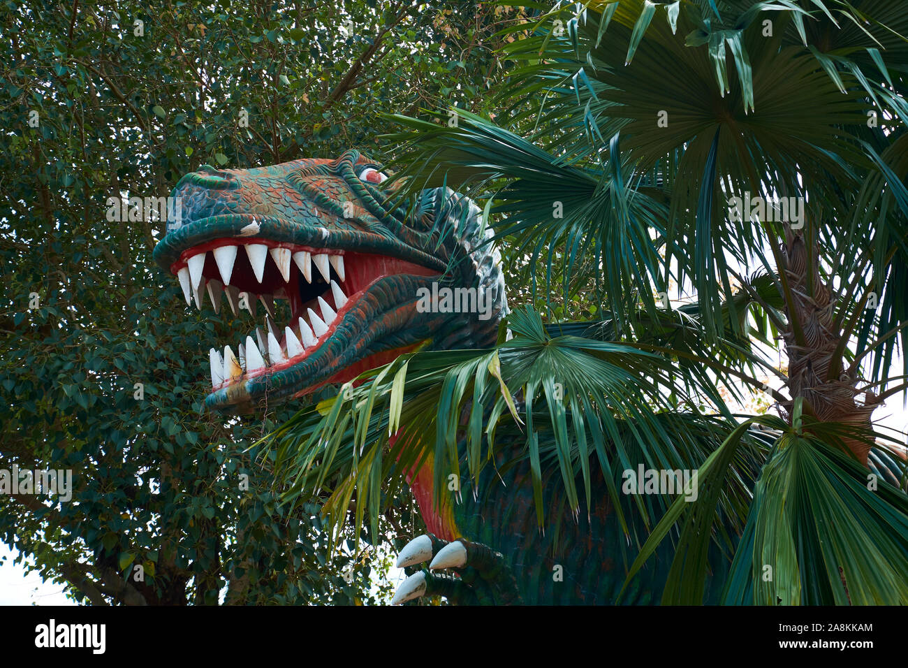 A big T-Rex concrete painted dinosaur sculpture at Buddhist Wat ...