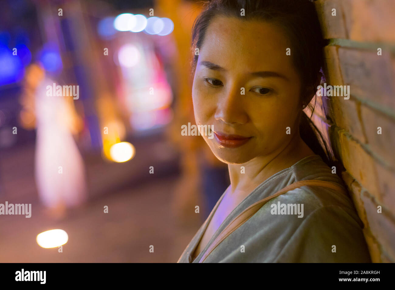 Portrait of Asian woman holding a traditional paper lantern during Yi ...