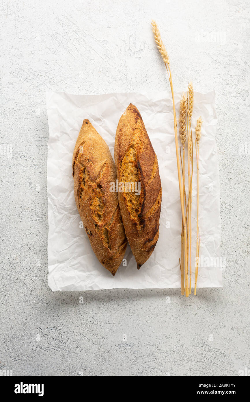 Bread top view on white background and wheats Stock Photo - Alamy