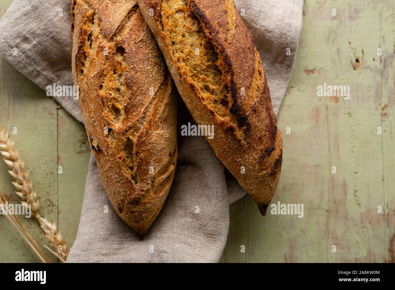 Two loaf of fresh breads on rustic wood Stock Photo - Alamy