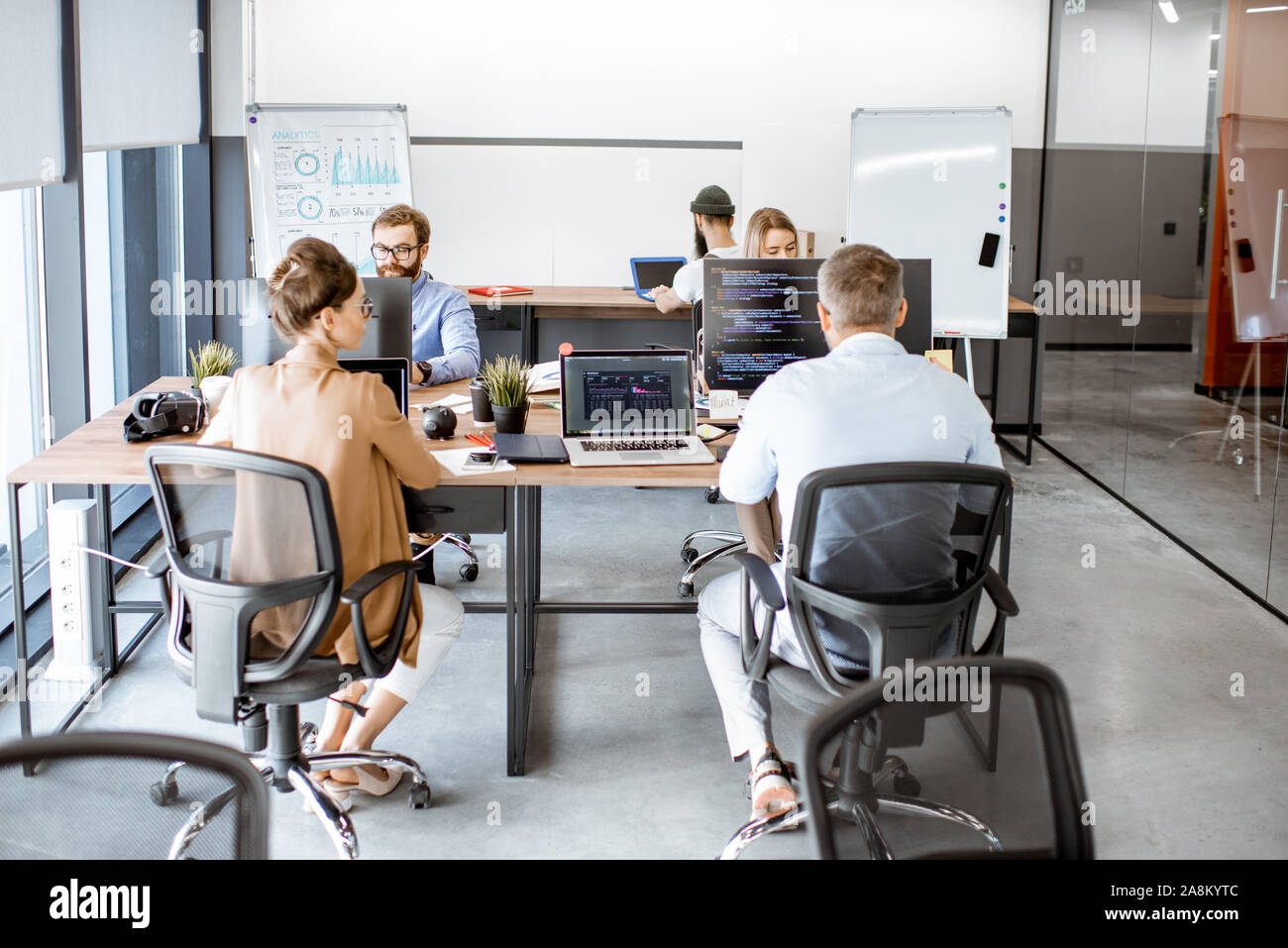 Group of diverse colleagues working on the computers in the modern ...