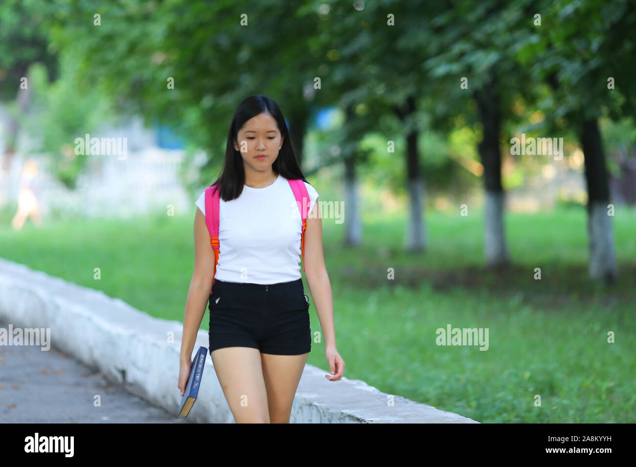 Young girl walking in the park are walking gait Stock Photo - Alamy