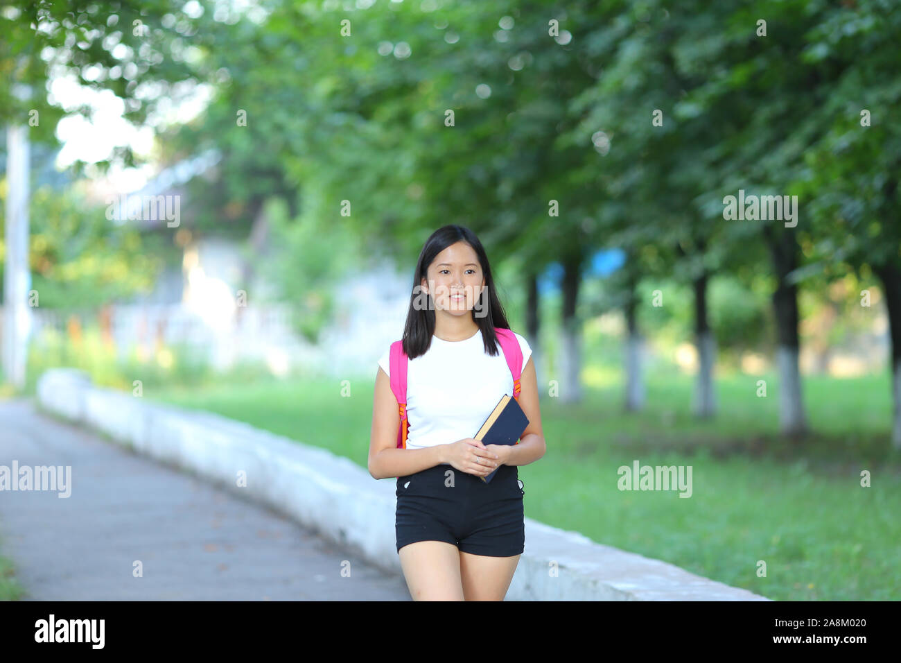 Young girl walking in the park are walking gait Stock Photo - Alamy