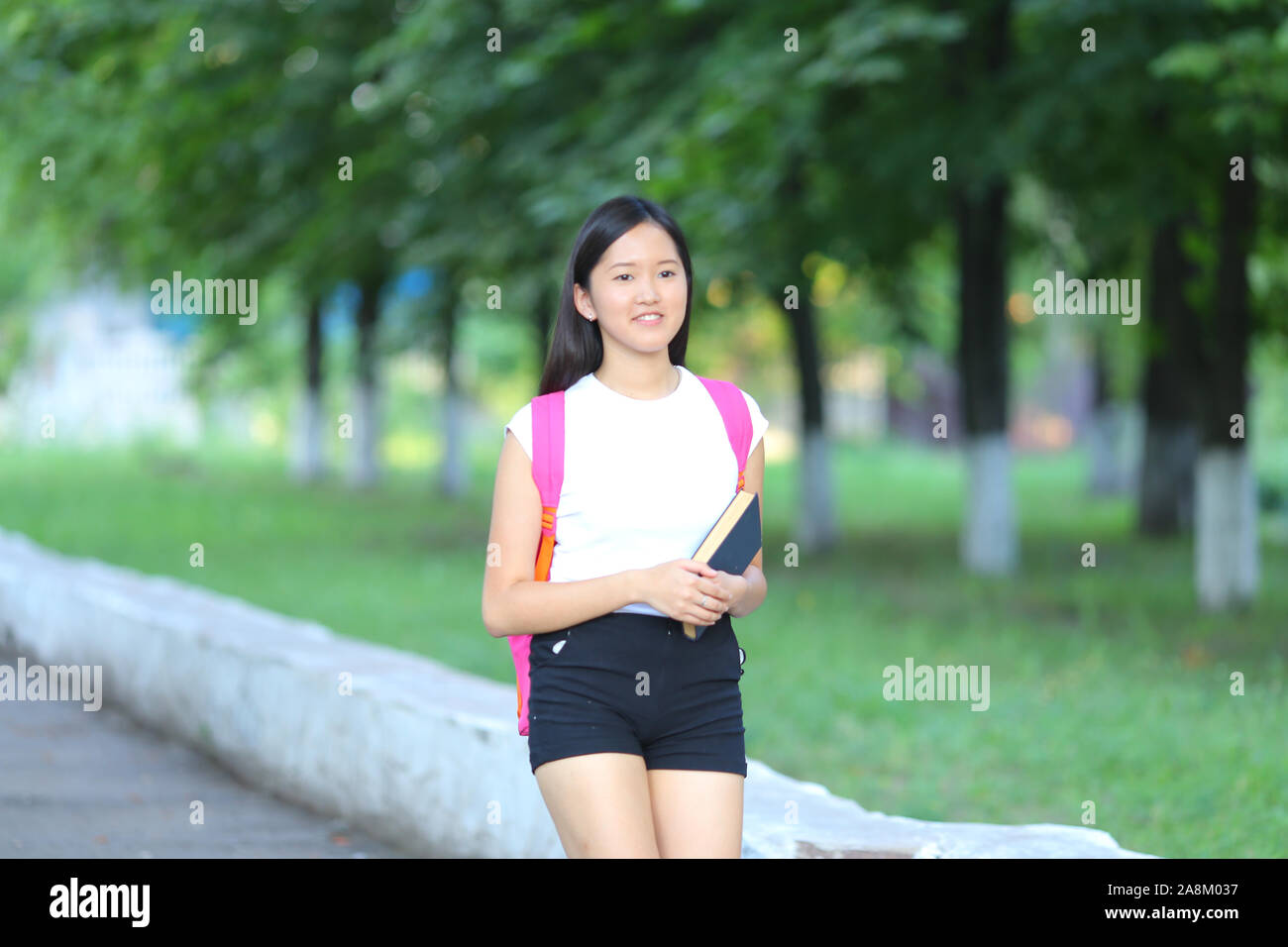 Young girl walking in the park are walking gait Stock Photo - Alamy