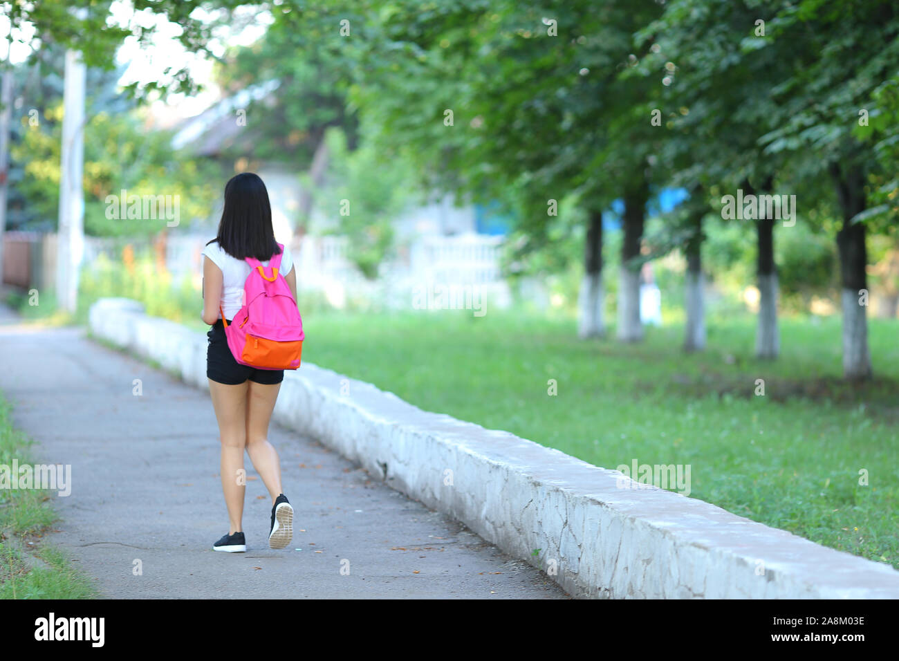 Young girl walking in the park are walking gait Stock Photo - Alamy