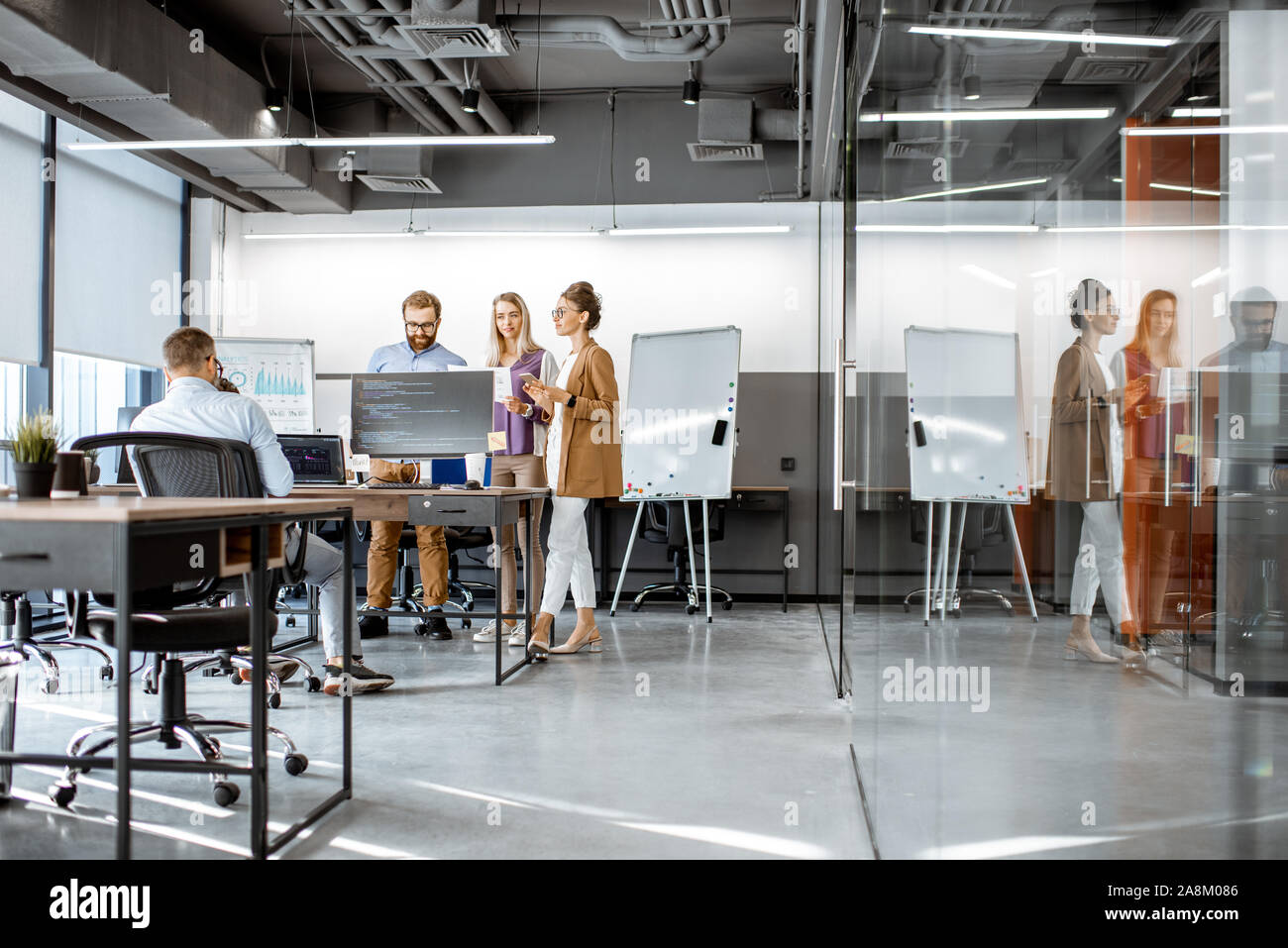 Interior view on the modern office room with diverse people working on ...