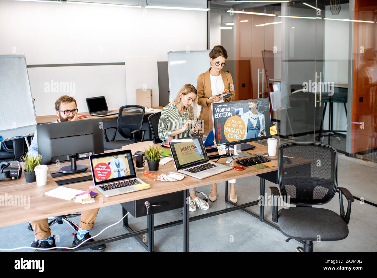 Modern office room of web designers with working places and people ...