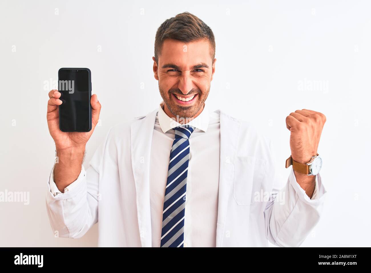 Young scientist man showing smartphone screen over isolated background ...
