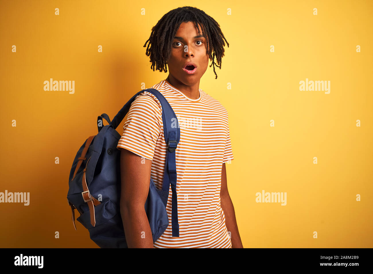 Afro american student man with dreadlocks wearing backpack over ...
