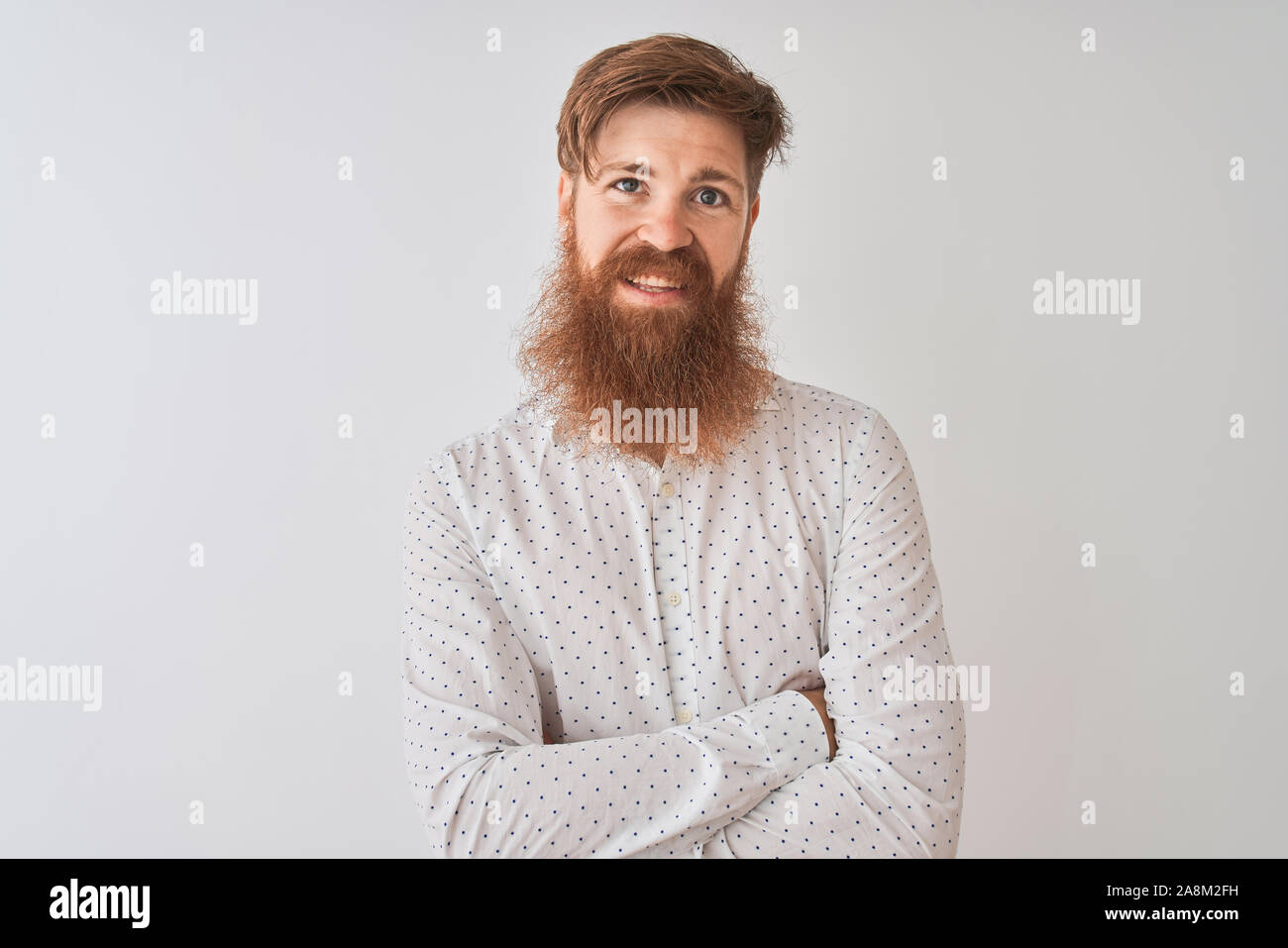 Young redhead irish man wearing shirt standing over isolated white ...