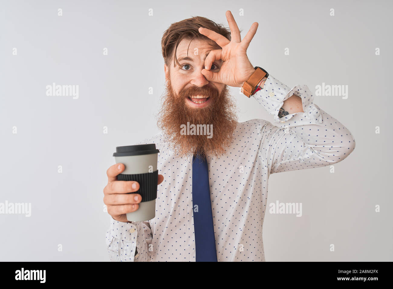 Young redhead irish man drinking take away coffee standing over ...