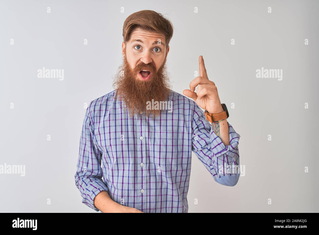 Young redhead irish man wearing casual shirt standing over isolated ...