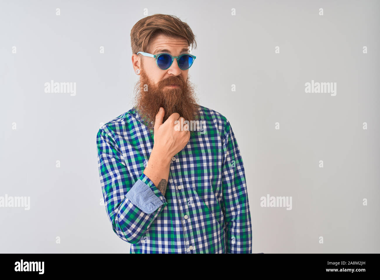 Young redhead irish man wearing casual shirt and sunglasses over ...