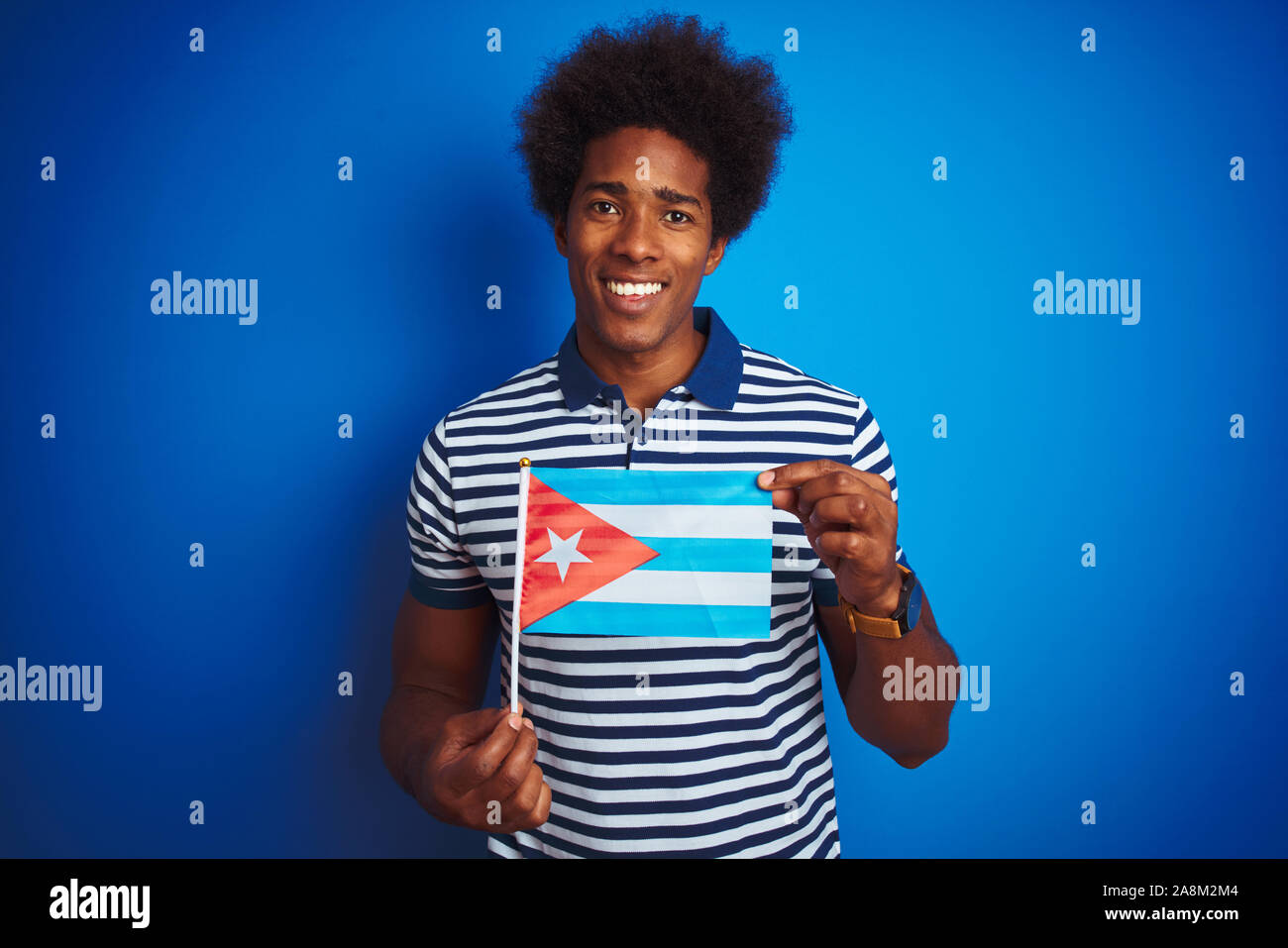 Young african american man holding Cuba Cuban flag standing over ...