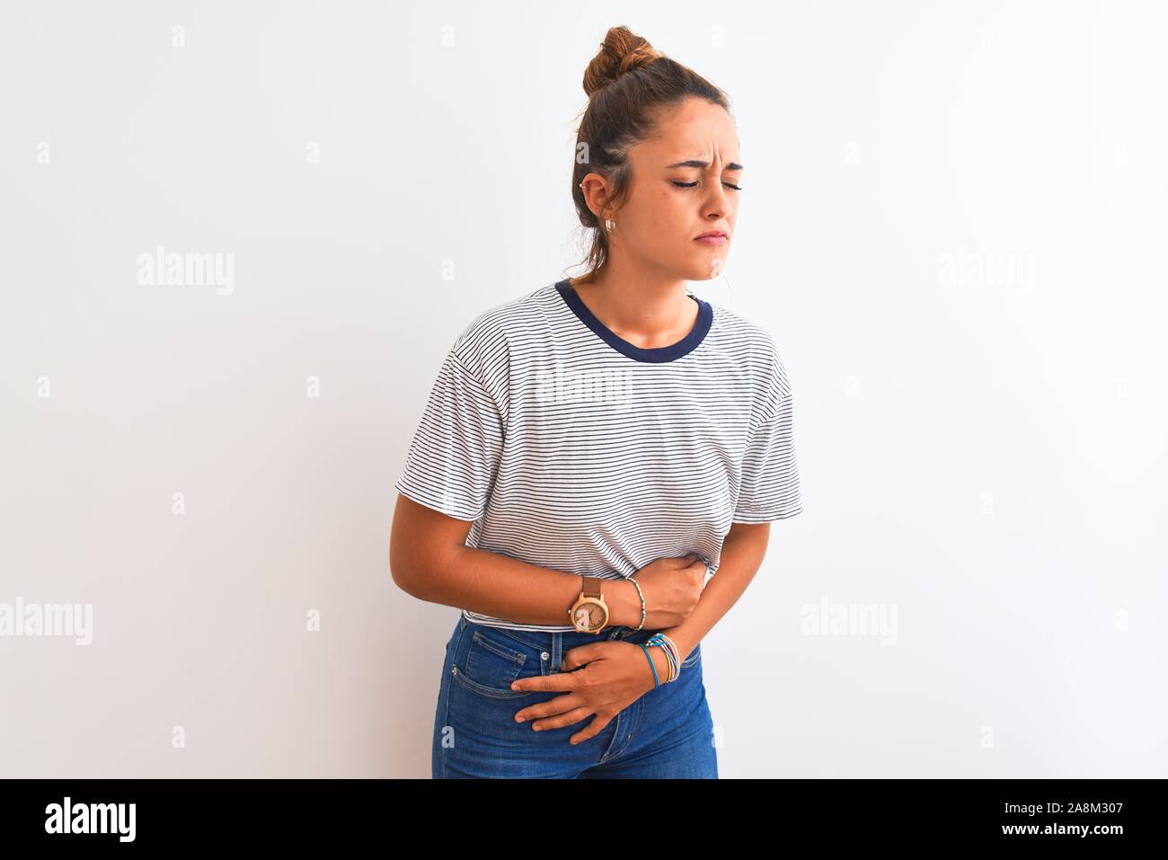 Young redhead modern woman wearing a bun over isolated background with ...