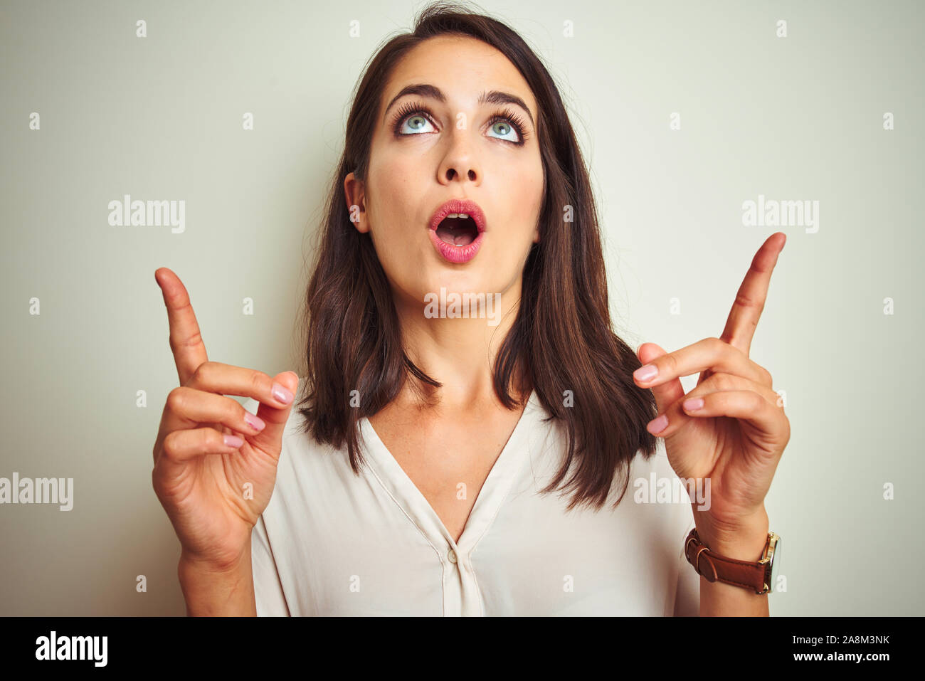 Young beautiful woman wearing casual shirt standing over white isolated ...