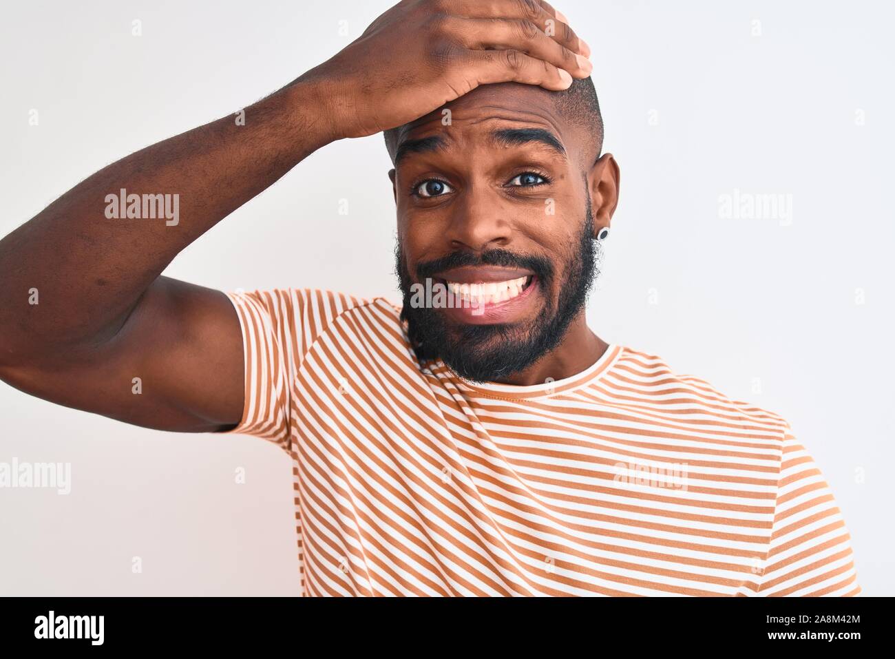 African american man with braids wearing striped t-shirt over isolated ...