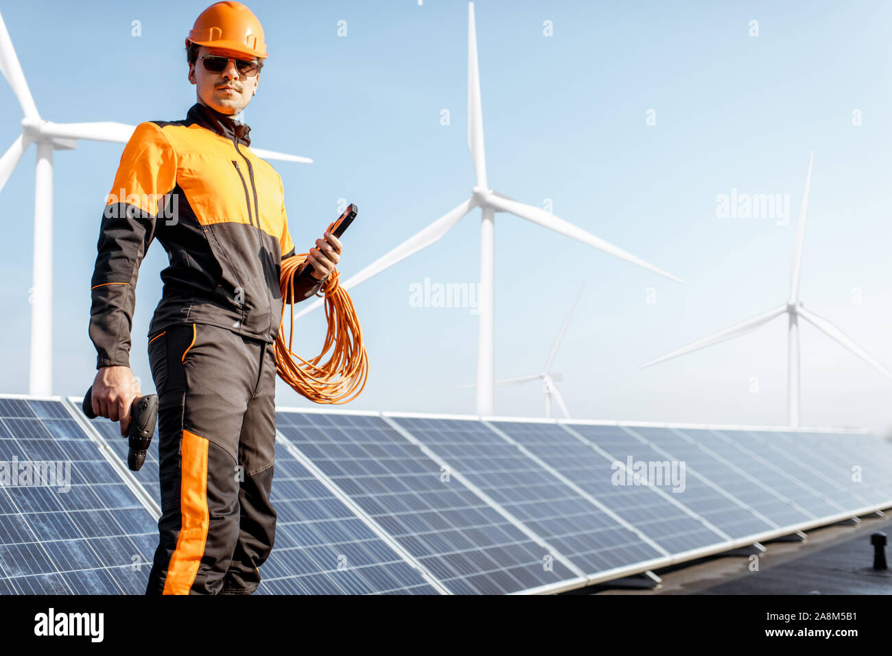 Portrait of a well-equipped worker in protective orange clothing ...