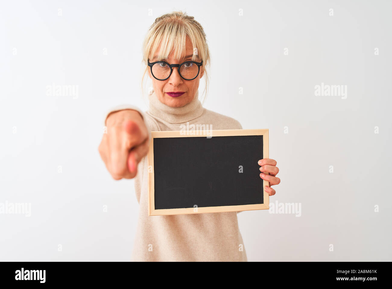 Middle age woman wearing glasses holding blackboard over isolated white ...