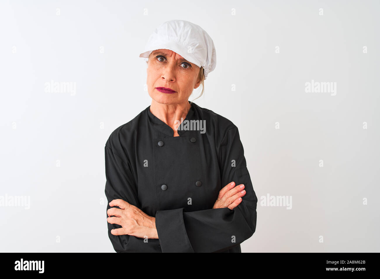 Middle age chef woman wearing uniform and cap standing over isolated ...