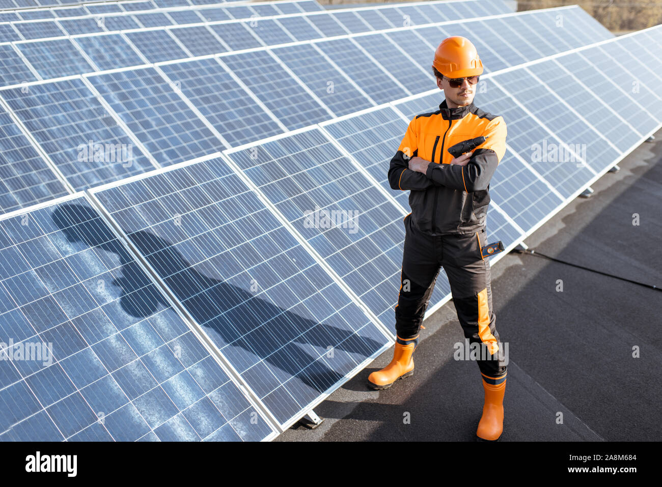 Portrait of a well-equipped worker in protective orange clothing ...
