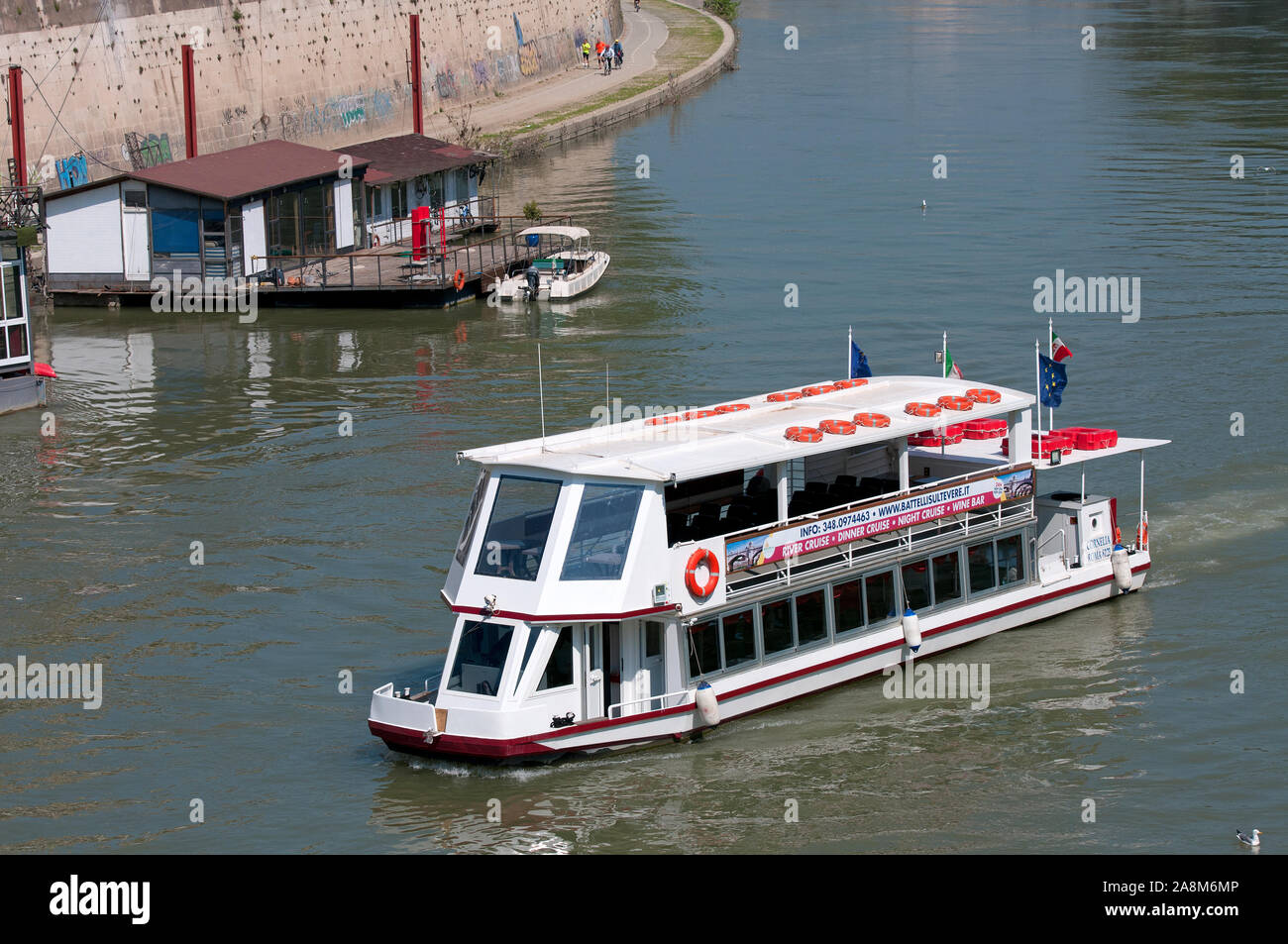 Tourist boat and floating house on the Tiber river, Rome, Lazio, Italy ...