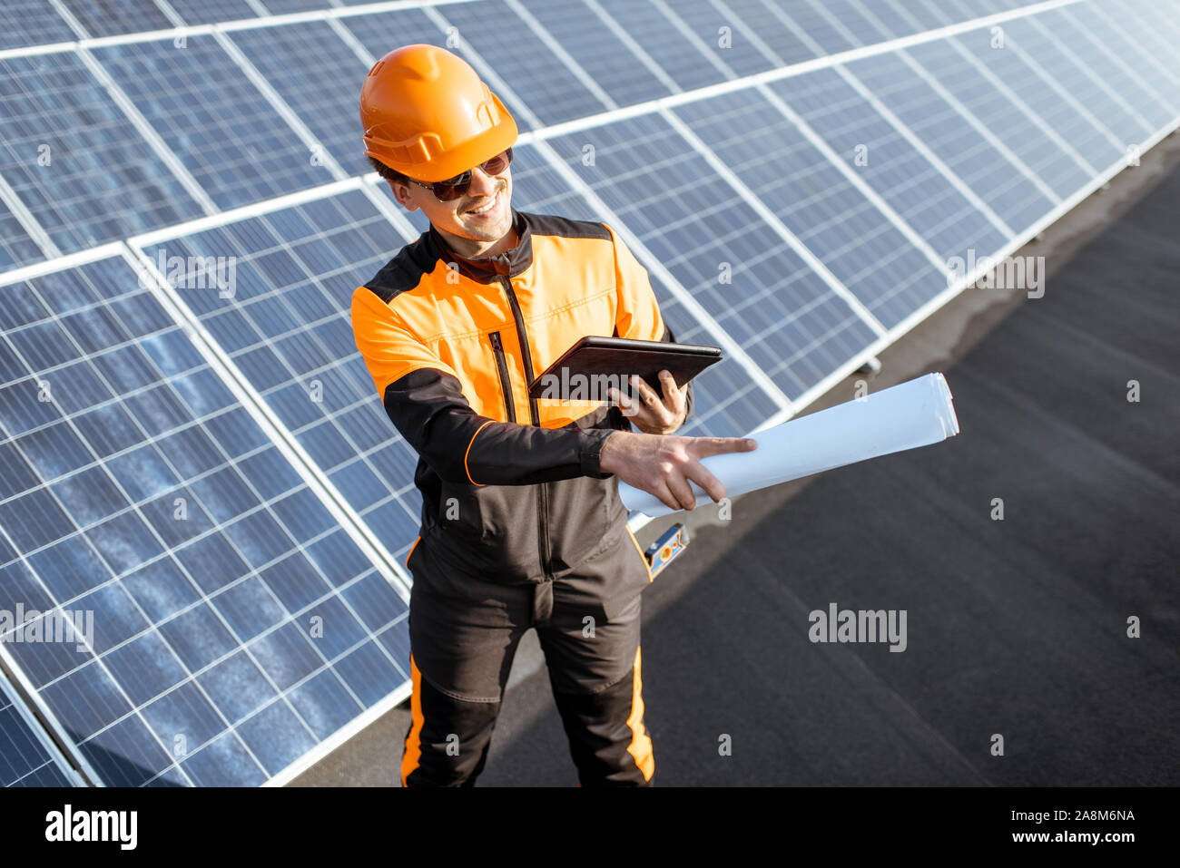 Portrait of an engineer in protective workwear carrying out service of ...