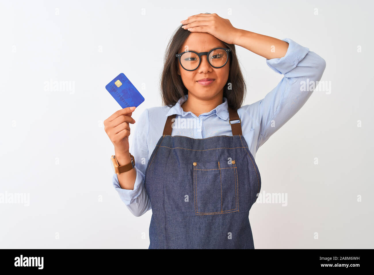 Chinese shopkeeper woman wearing glasses holding credit card over ...
