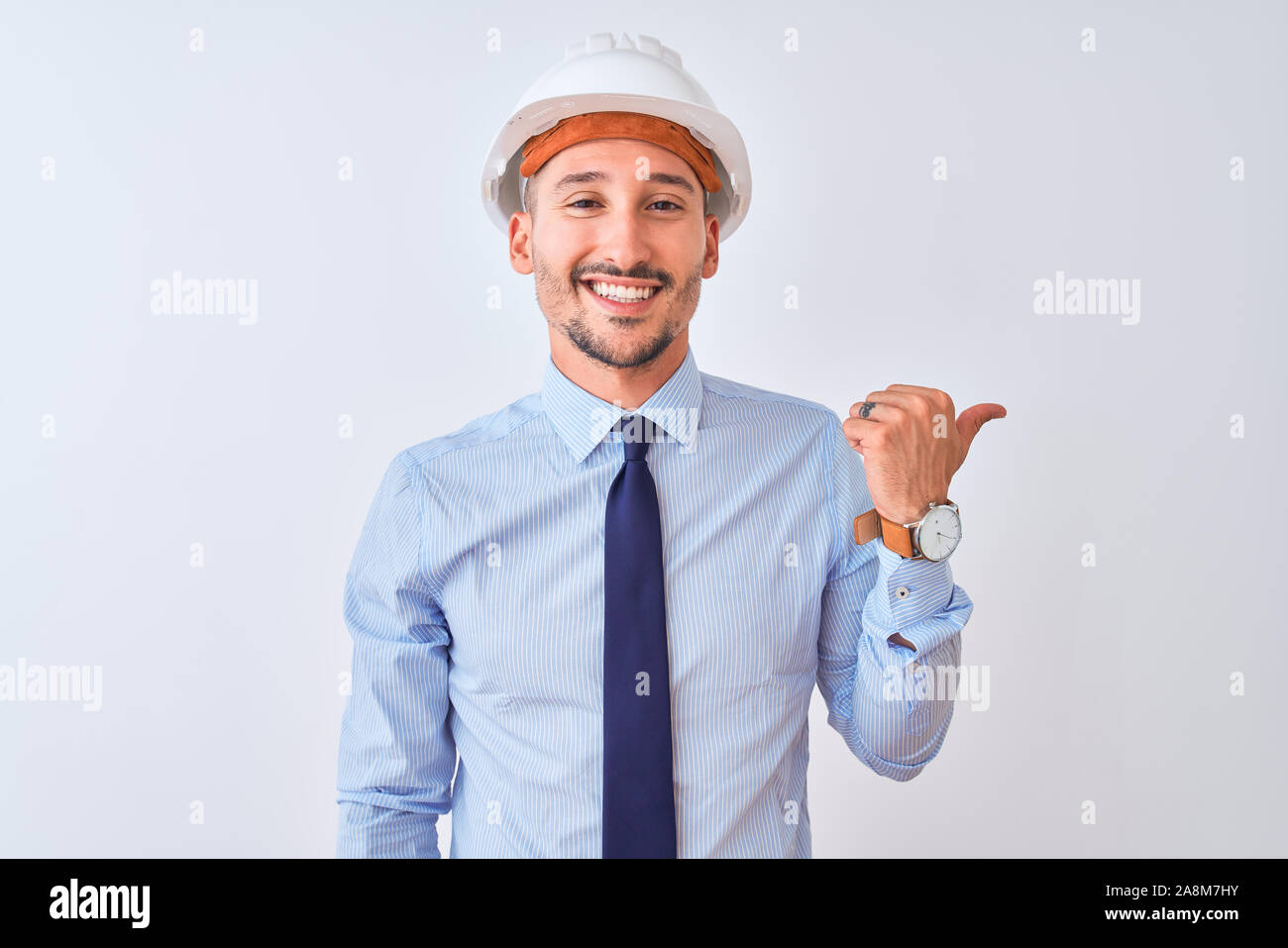 Young business man wearing contractor safety helmet over isolated ...