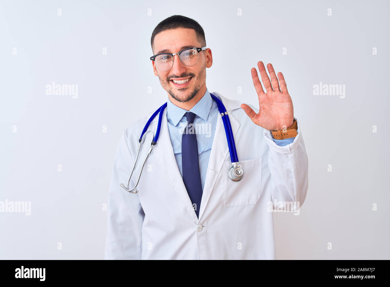 Young doctor man wearing stethoscope over isolated background Waiving ...