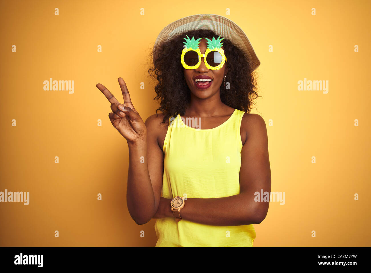 African american woman wearing funny pineapple sunglasses over isolated ...