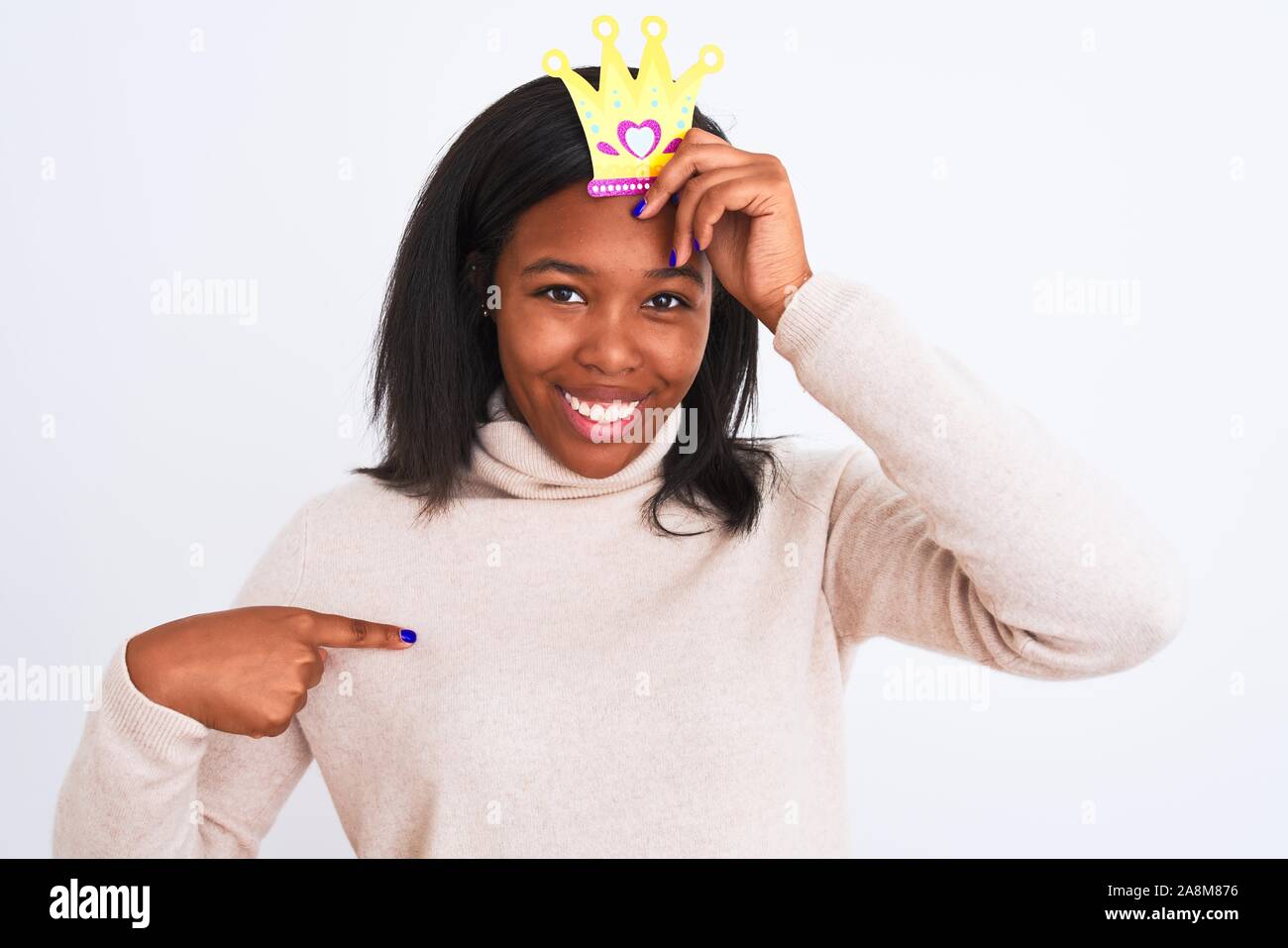 Young african american woman wearing pretend queen crown over isolated ...