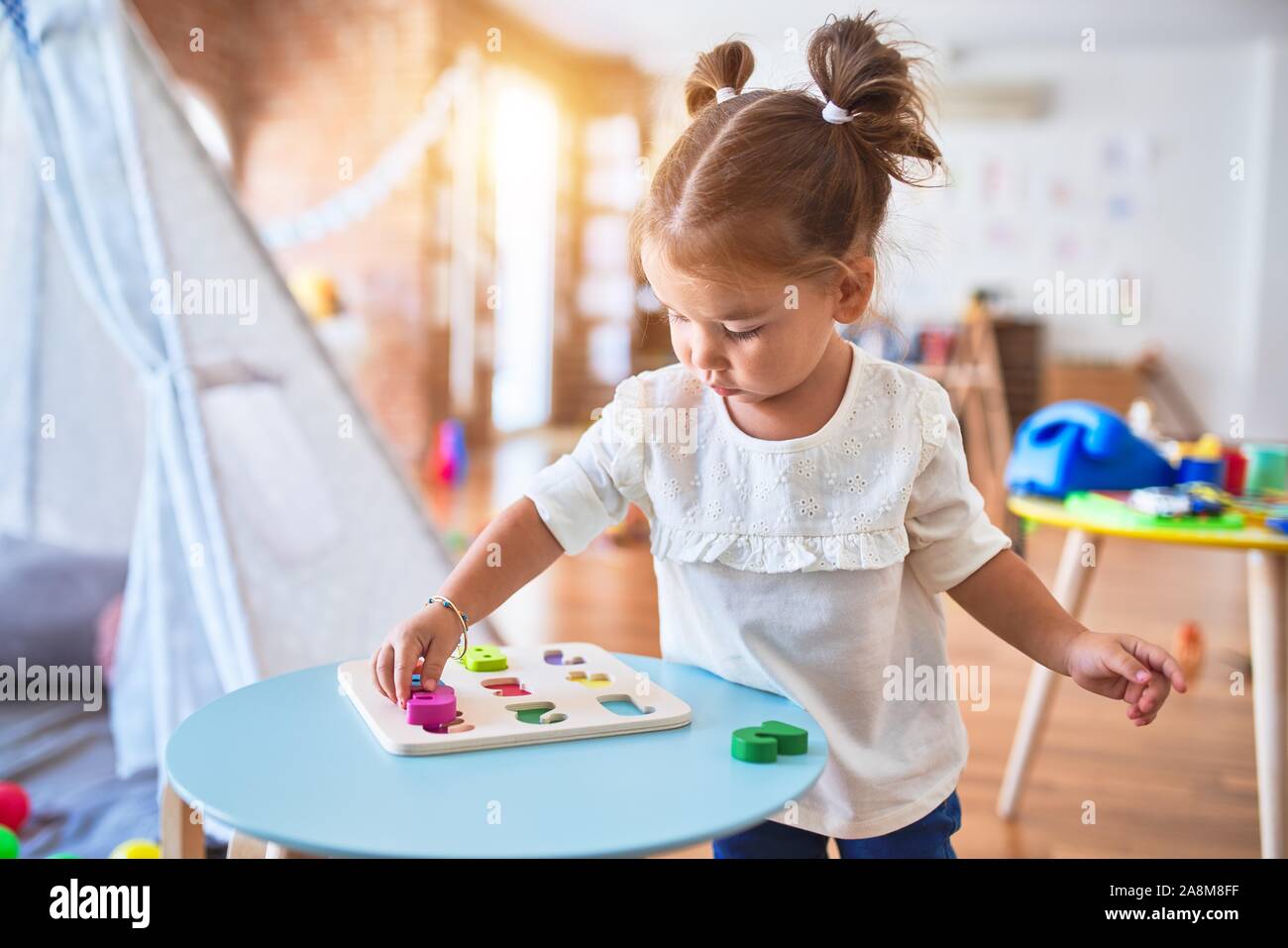 Young beautiful toddler learning mathematics playing with maths game at ...