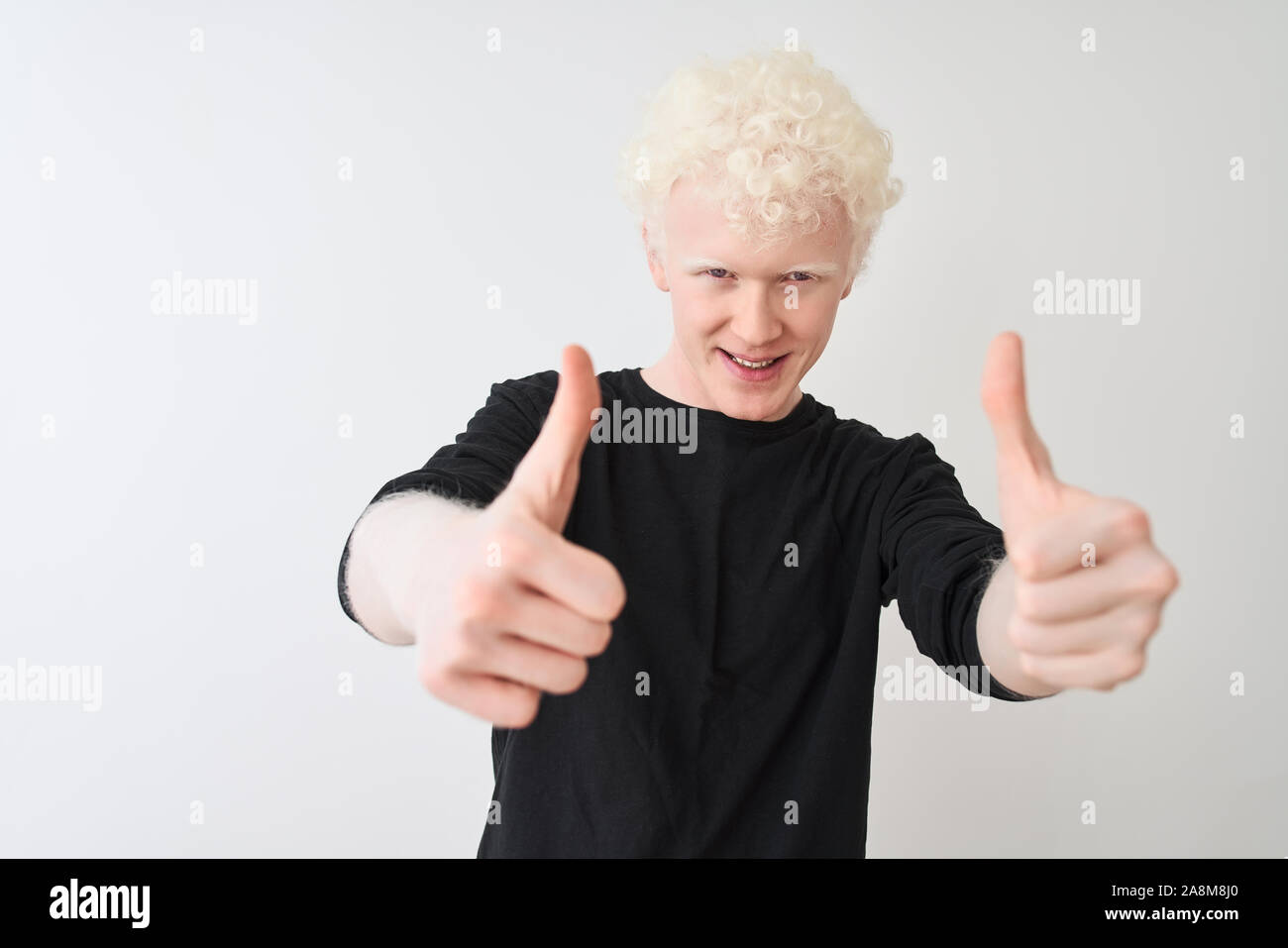 Young albino blond man wearing black t-shirt standing over isolated ...