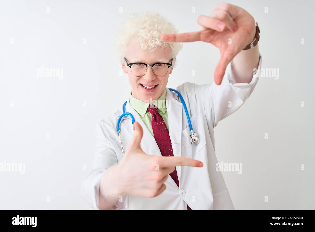 Young albino doctor man wearing stethoscope standing over isolated ...