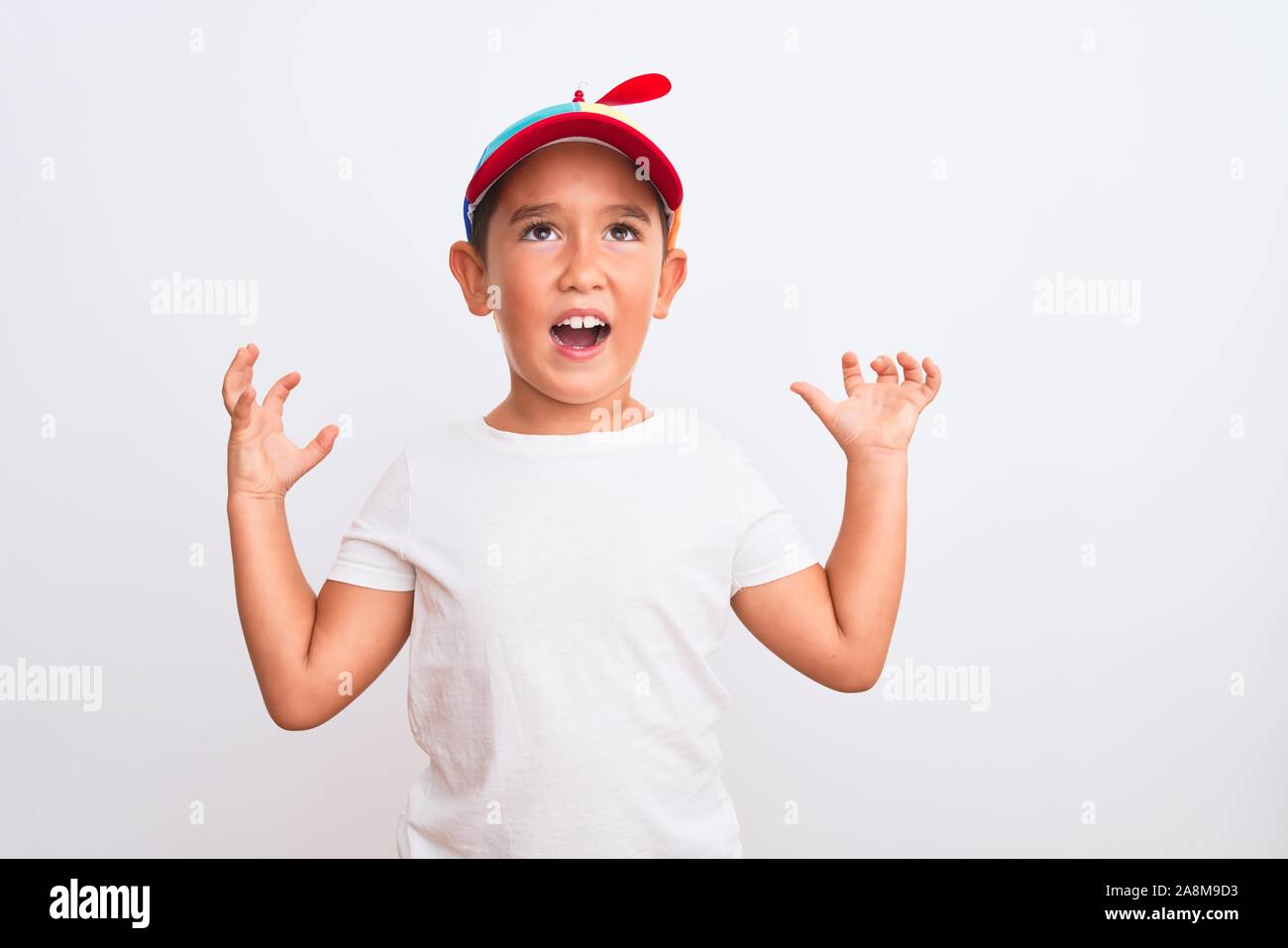 Beautiful kid boy wearing fanny colorful cap with propeller over ...