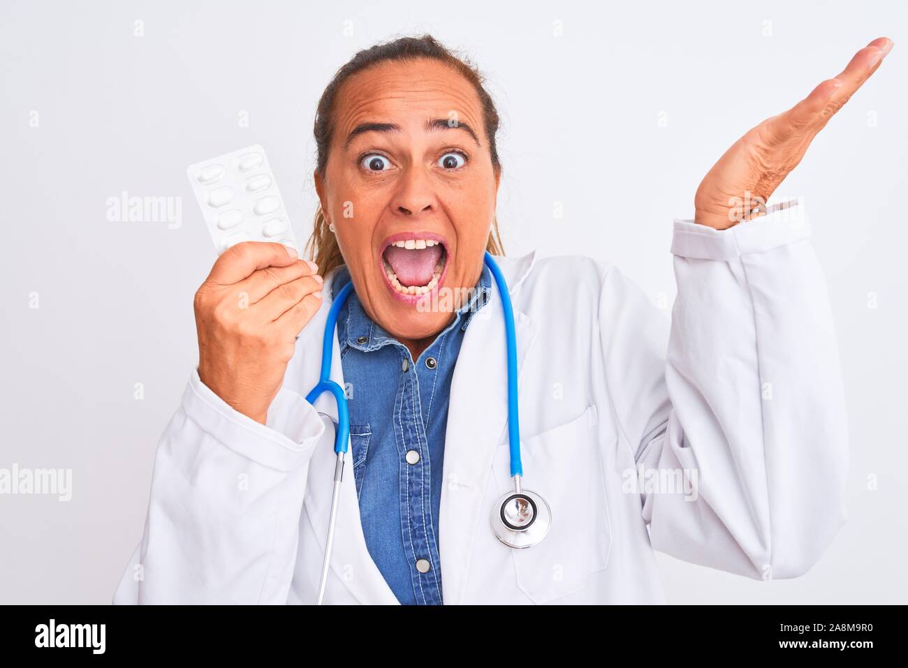 Middle age mature doctor woman showing prescription pills over isolated ...