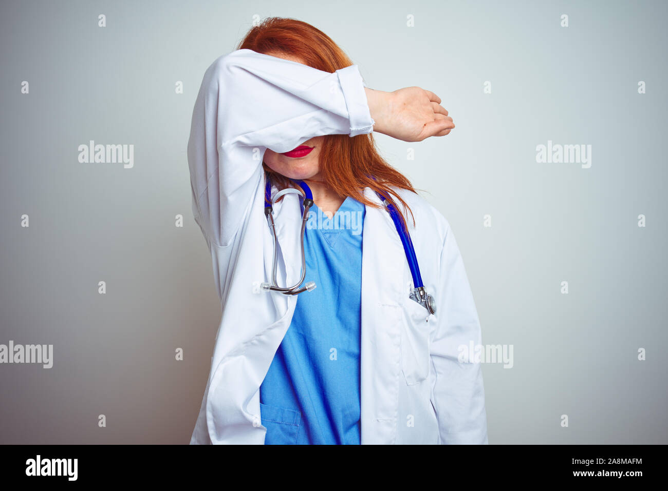 Young redhead doctor woman using stethoscope over white isolated ...