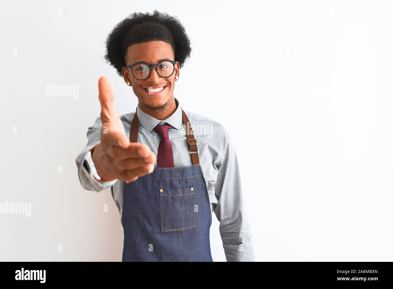 Young african american shopkeeper man wearing apron glasses over ...
