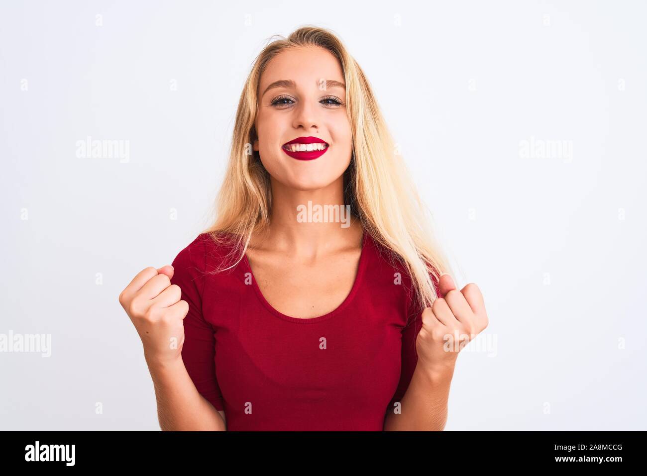 Young beautiful woman wearing red t-shirt standing over isolated white ...