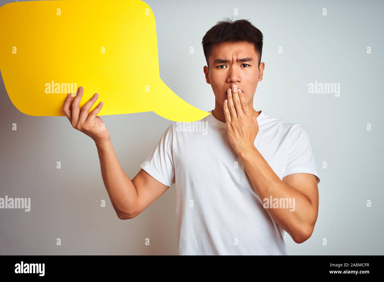 Asian chinese man holding speech bubble standing over isolated white ...