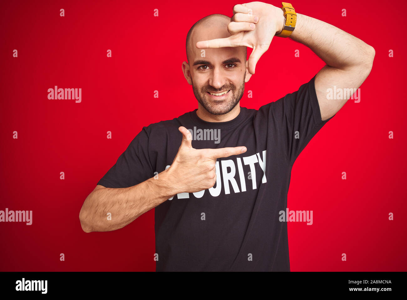 Young safeguard man wearing security uniform over red isolated ...