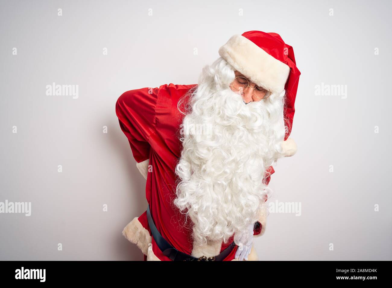 Middle age handsome man wearing Santa costume standing over isolated ...