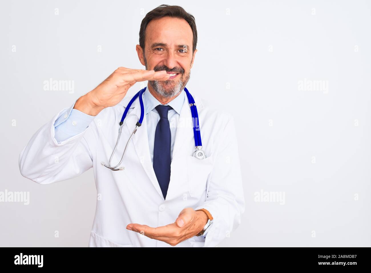 Middle age doctor man wearing coat and stethoscope standing over ...