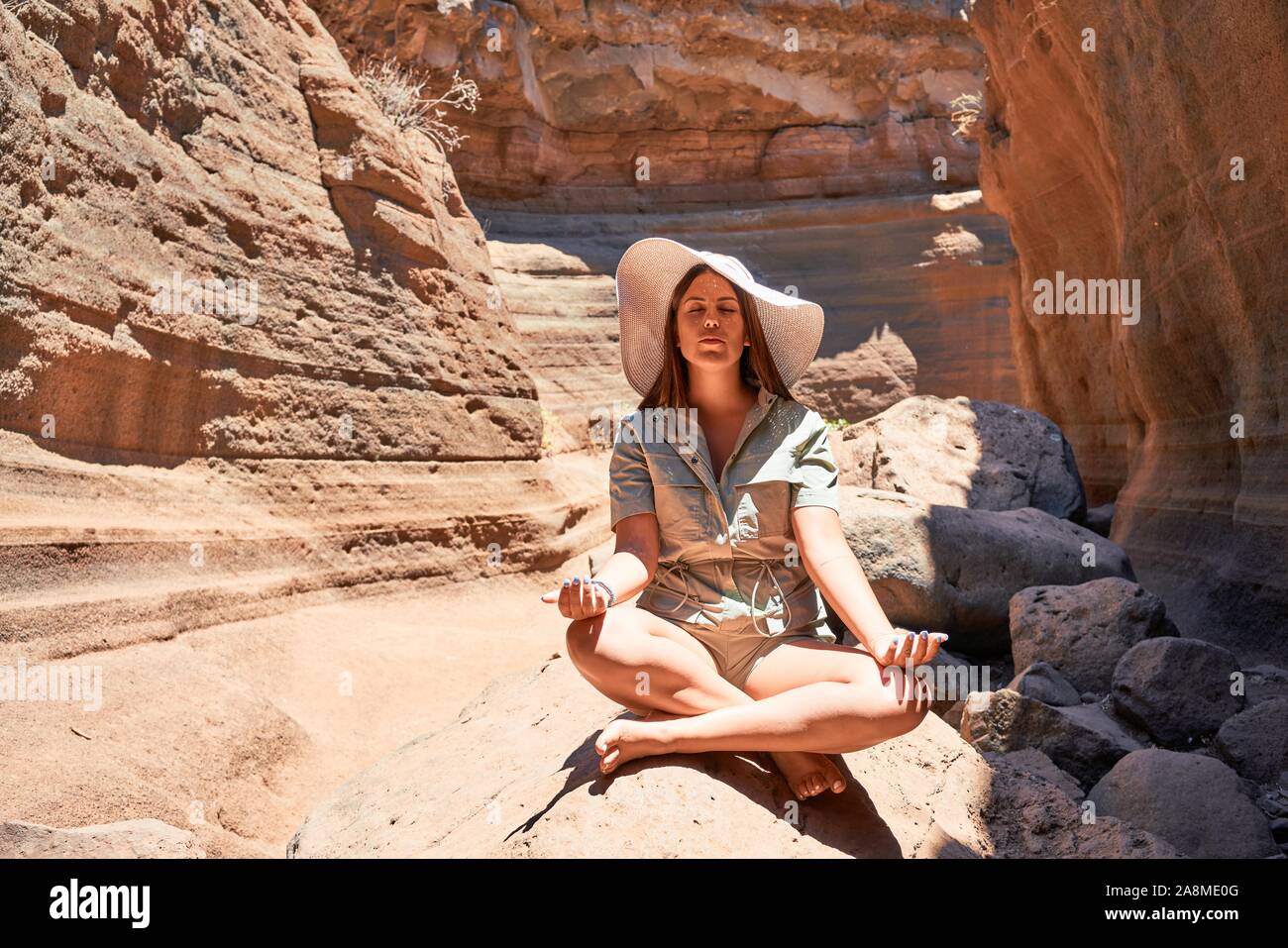 Young beauitufl hiker woman trekking natural orange mountain doing yoga ...