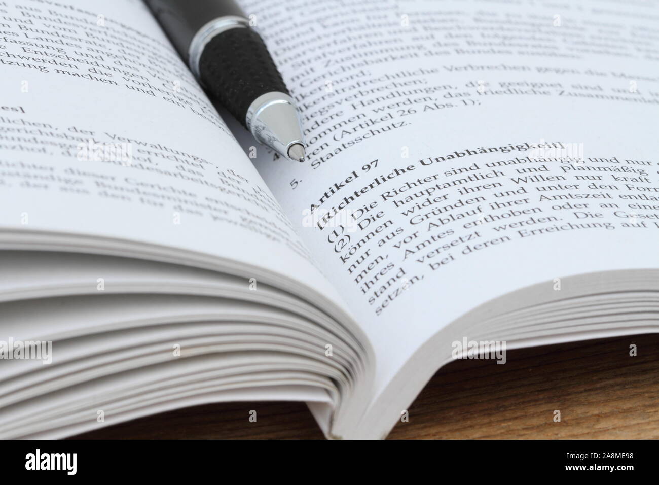 an open book with pen and the text "article Stock Photo - Alamy