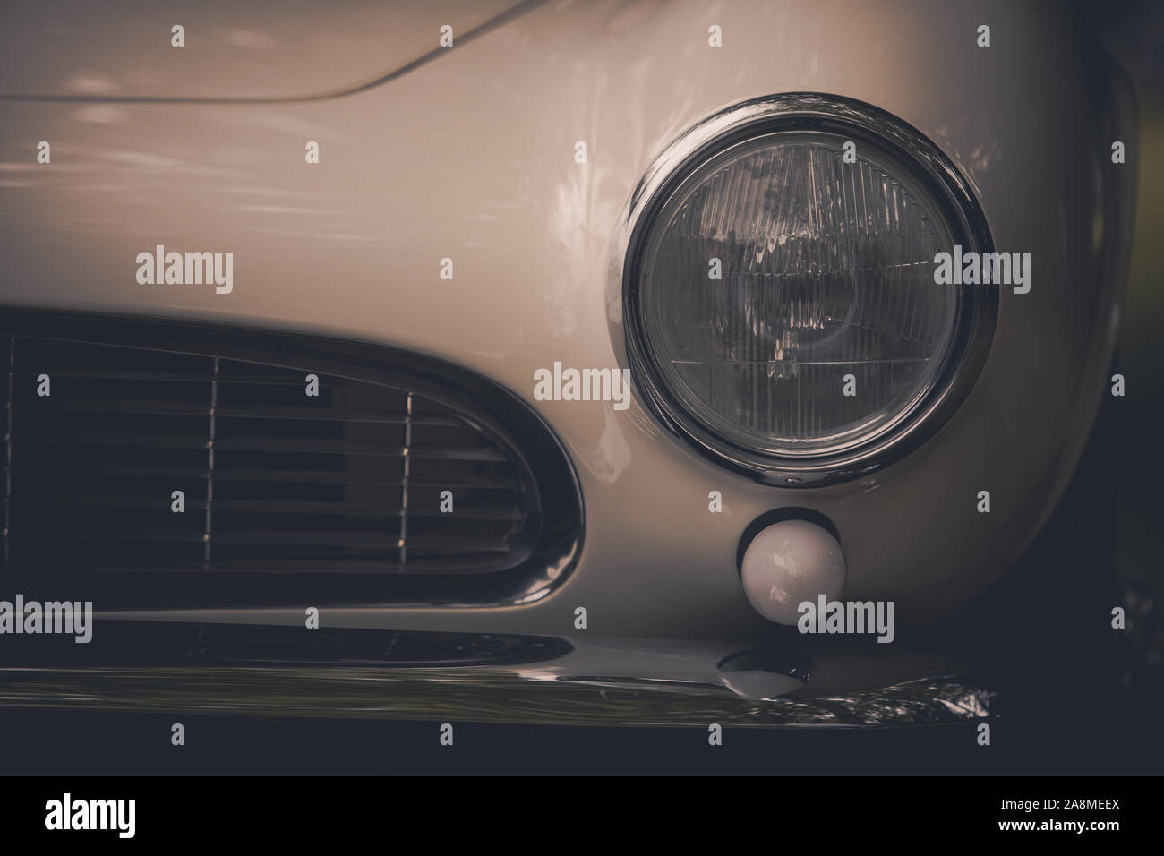 Close up horizontal image of the headlight of a vintage classic car ...