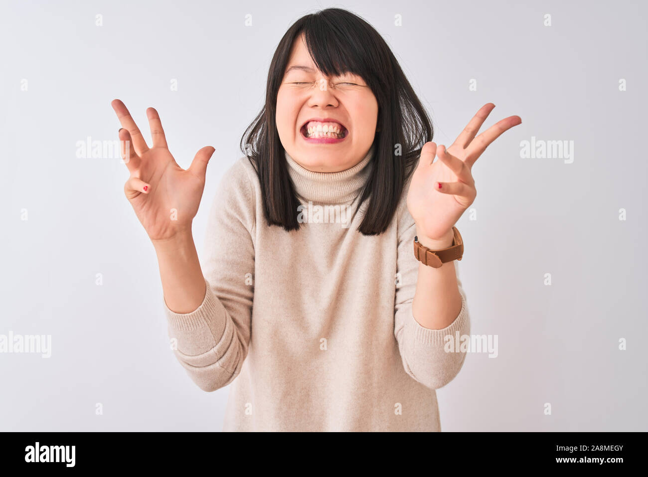 Young beautiful chinese woman wearing turtleneck sweater over isolated ...