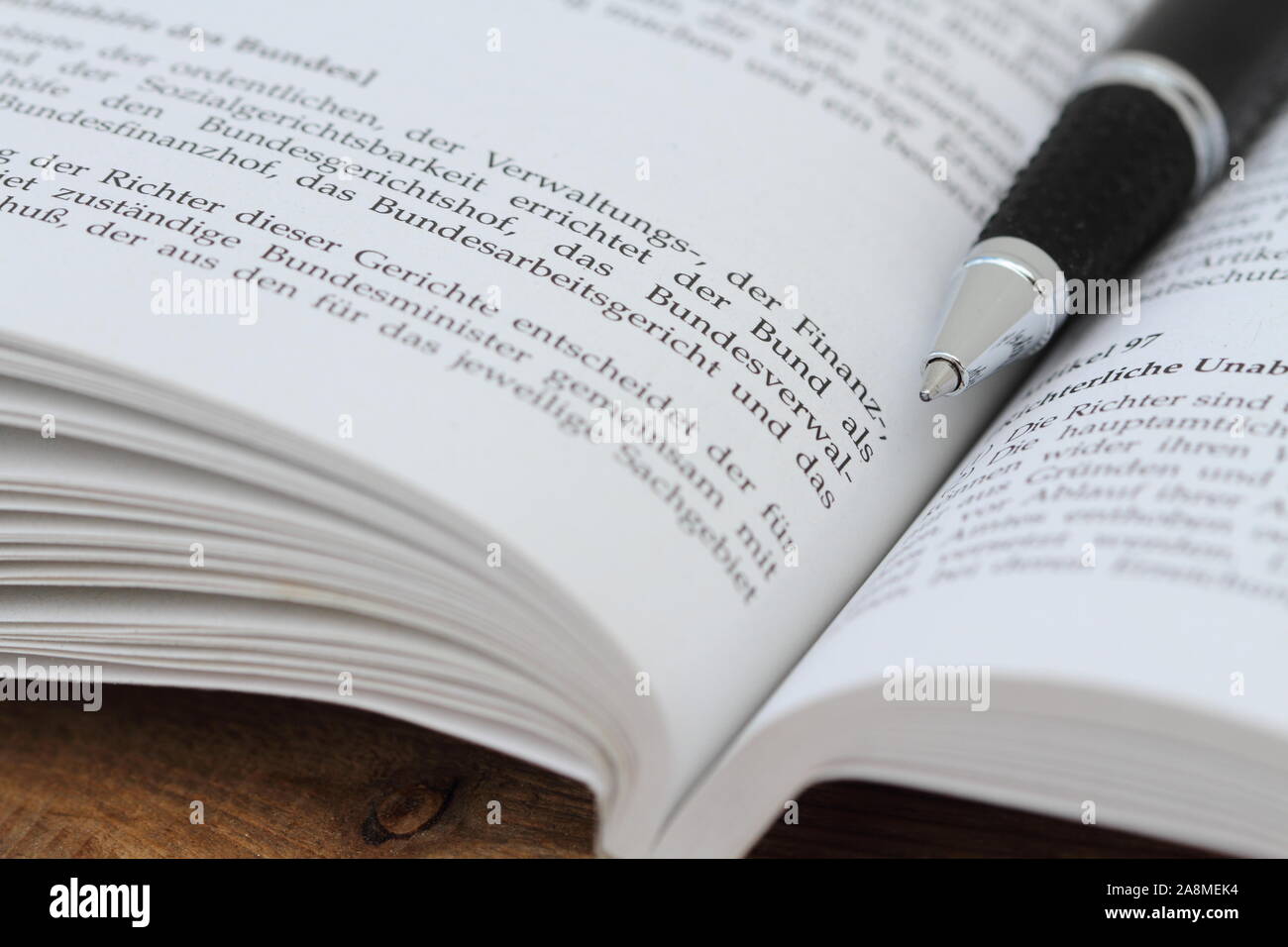 an open book with pen and the text "article Stock Photo - Alamy